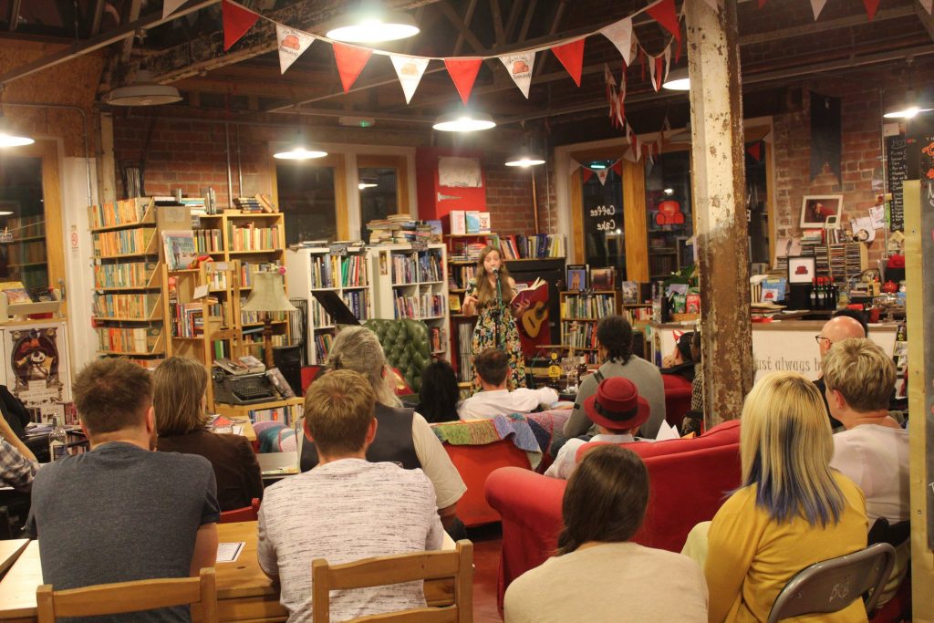 Leanne crowded shop - Here Comes Everyone